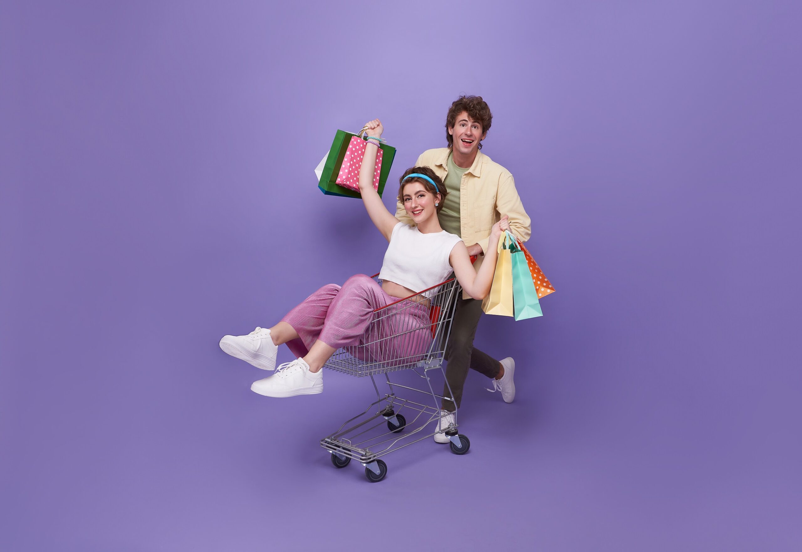 Full size young cheerful couple have fun drive shopping trolley - Curvy ...